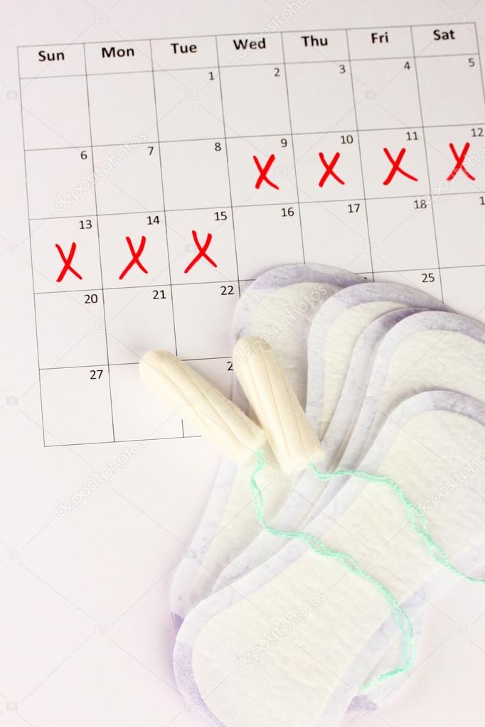 Menstruation calendar with sanitary pads and tampons, close-up — Stock ...