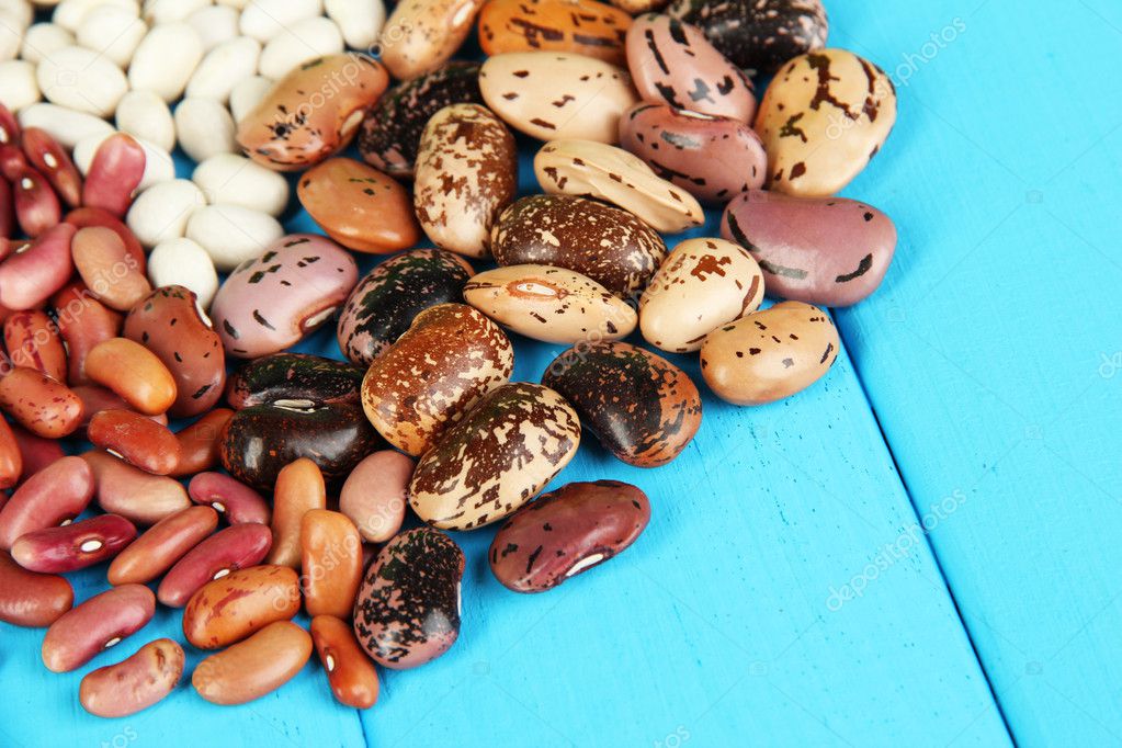 Different types of beans close-up on blue wooden table Stock Photo by ...