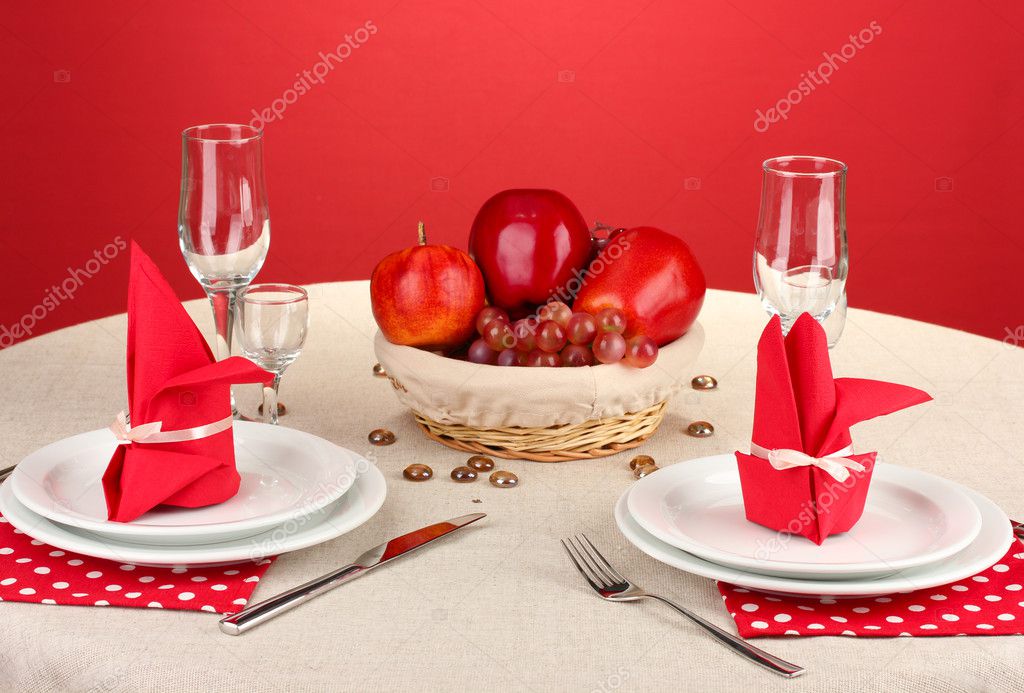 Table setting in red tones on color background — Stock Photo ...