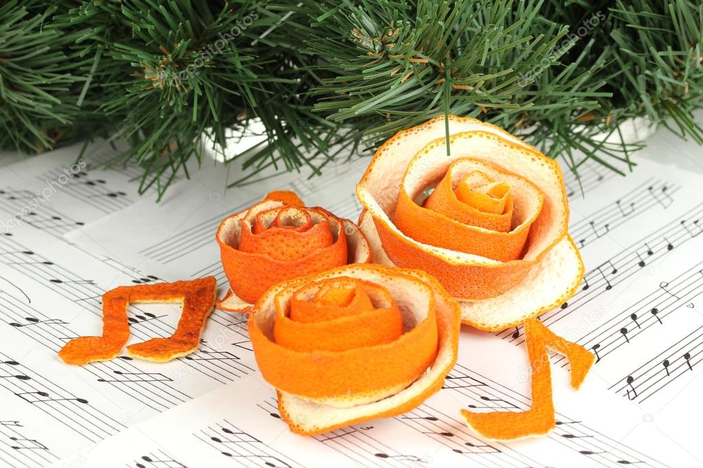 Decorative rose from dry orange peel on musical notes — Stock Photo ...