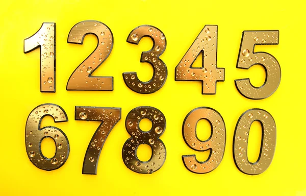 Golden numbers, isolated on white — Stock Photo © belchonock #19159979