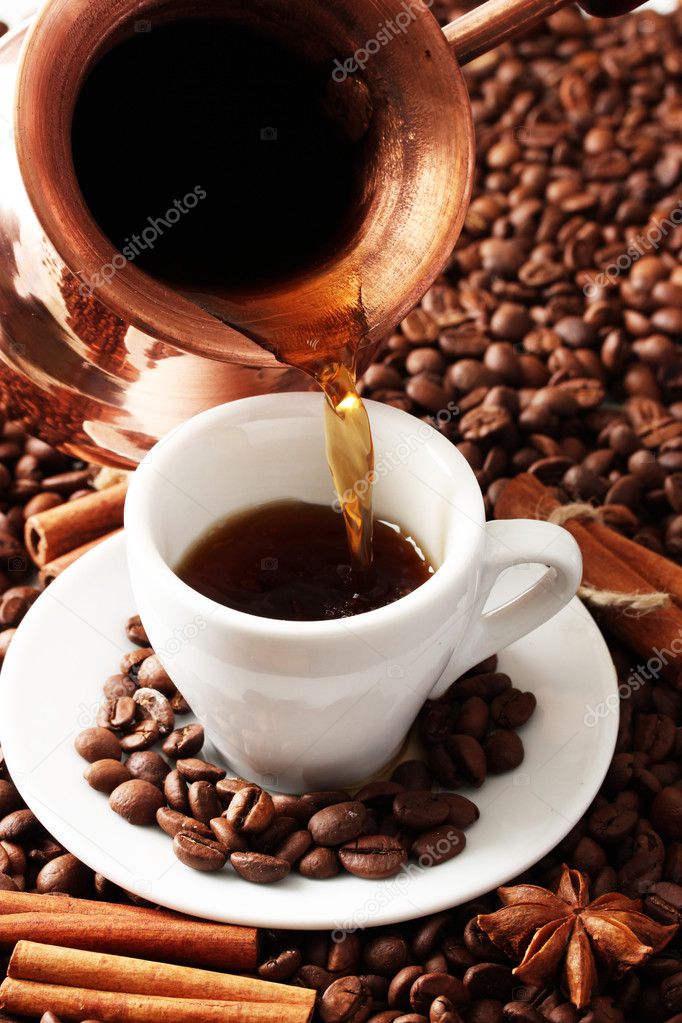 Cup and pot of coffee on coffee beans background — Stock Photo ...