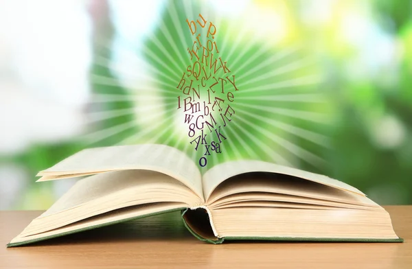 Opened book with letters flying out of it on bright background Stock ... Opened book with letters flying out of it on bright background Stock ...