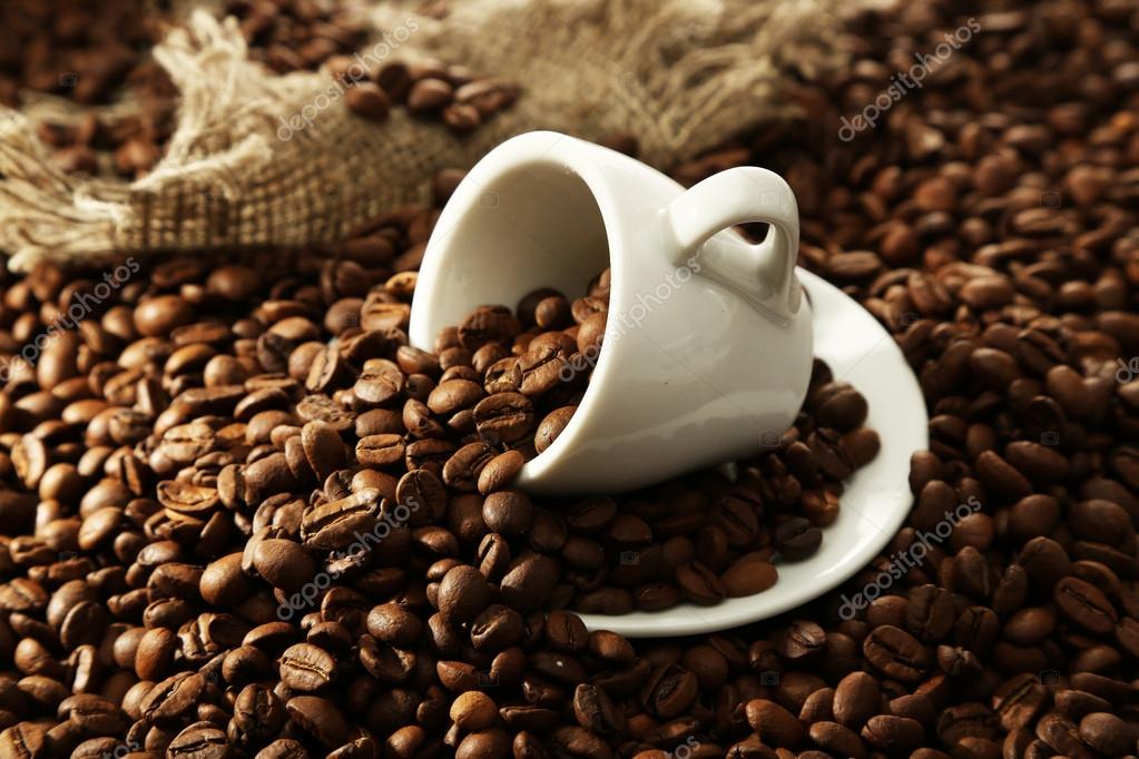 Cup with coffee beans, close up Stock Photo by ©belchonock 21922437