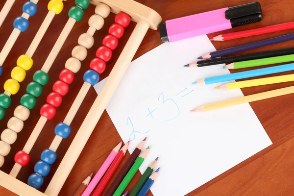 Toy abacus, note paper, pencils on bright background - Stock Image ...
