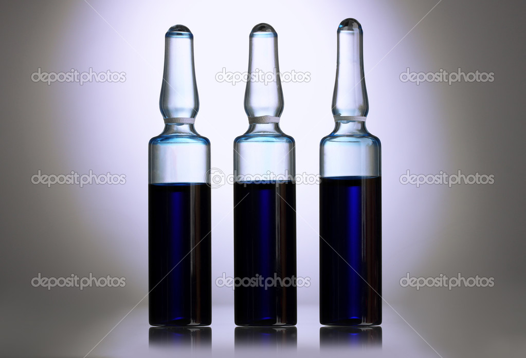 Medical ampules on grey background Stock Photo by ©belchonock 22527021