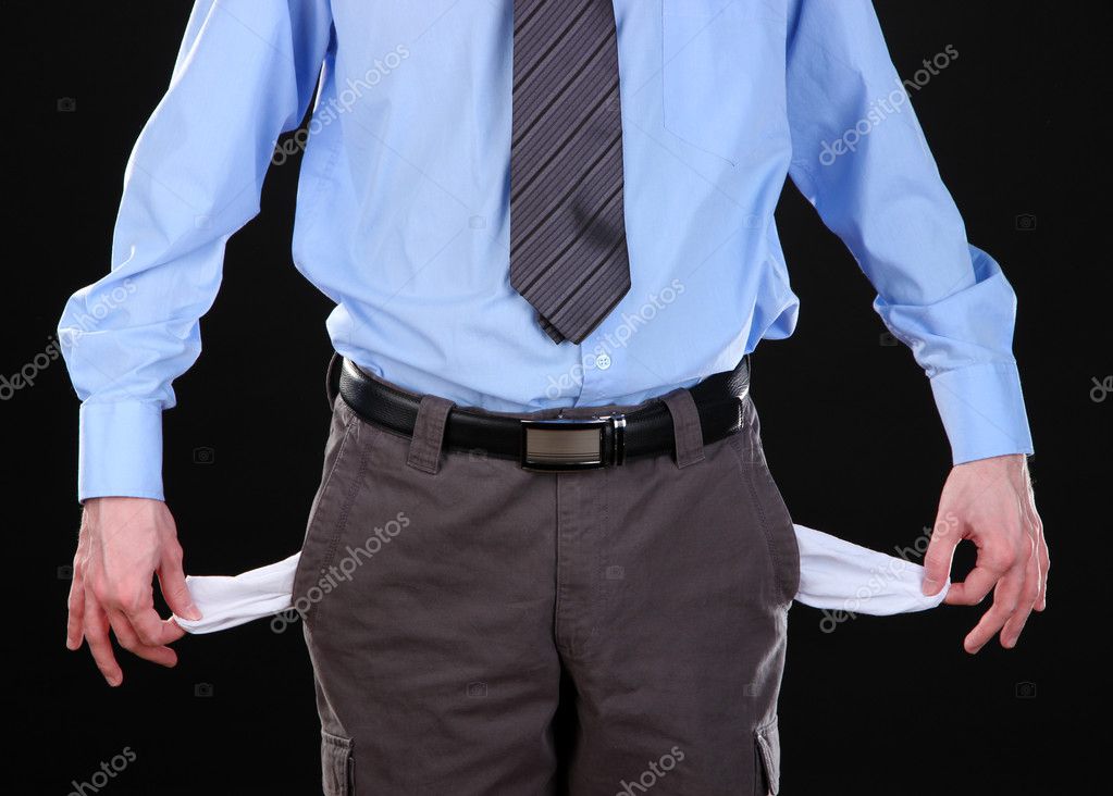 Business man showing his empty pockets, on black background Stock Photo ...