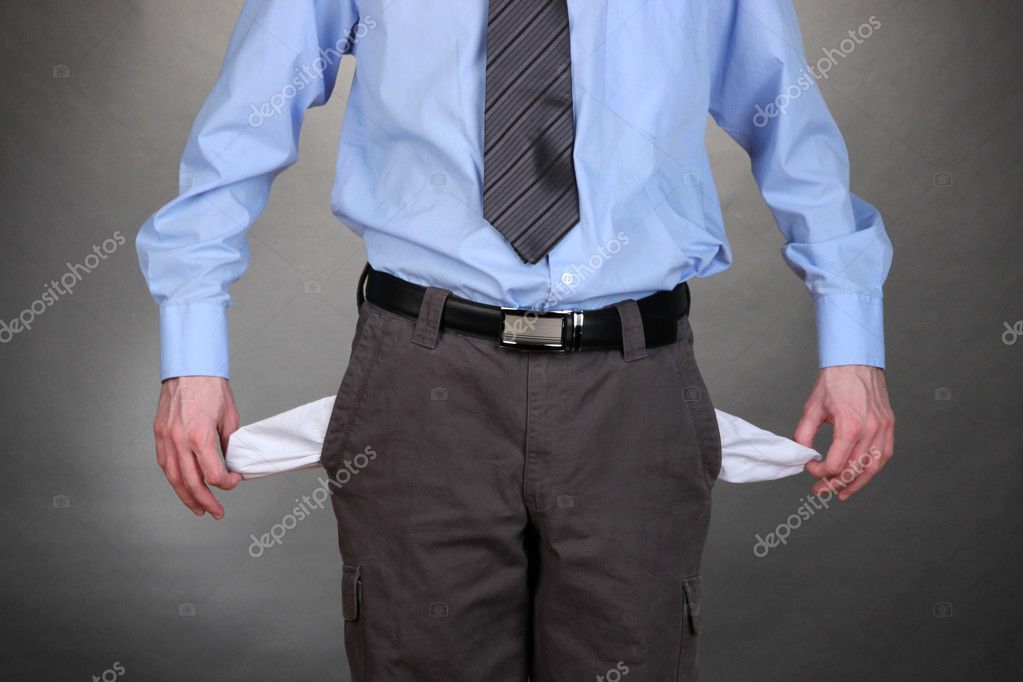 Business man showing his empty pockets, on grey background — Stock ...