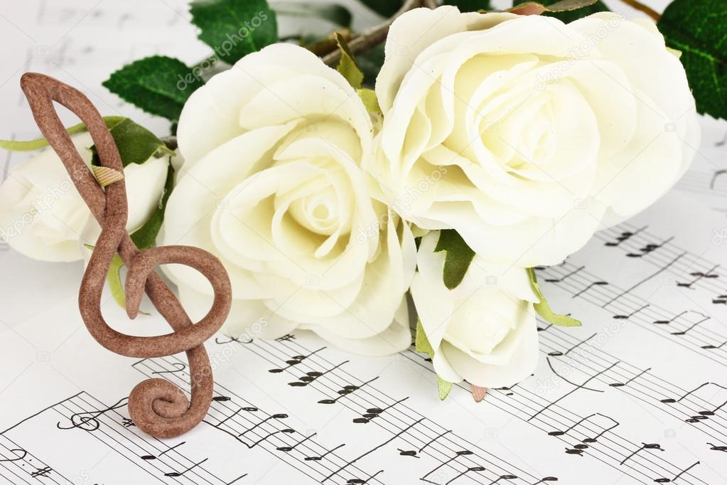 Treble clef and roses on musical background — Stock Photo © belchonock ...
