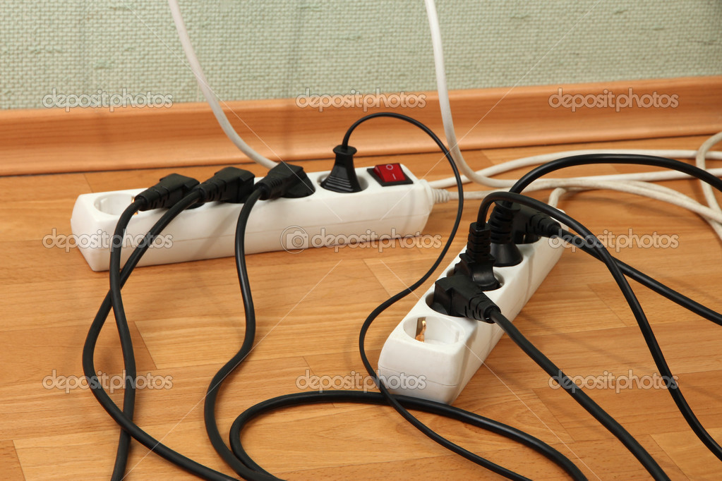 Overloaded power boards, close up Stock Photo by ©belchonock 24507435