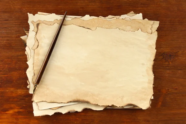 Old paper, ink and scrolls on wooden background Stock Photo by ...