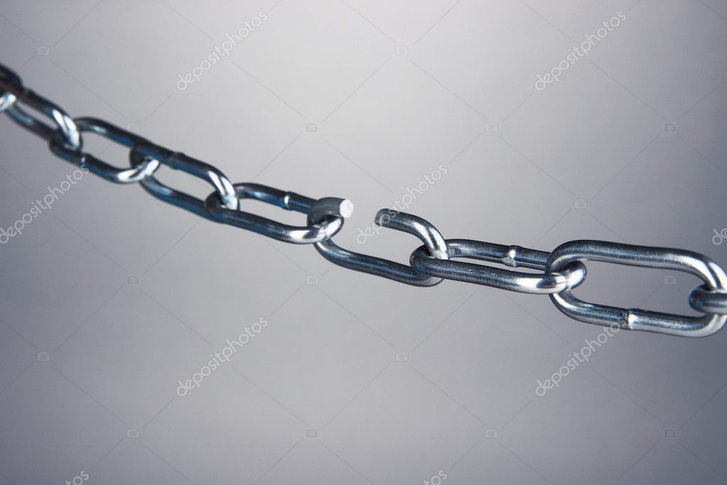 Broken chain on gray background Stock Photo by ©belchonock 25190447