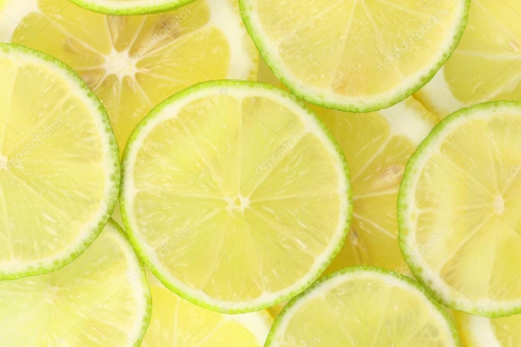 Lime and lemon slices background Stock Photo by ©belchonock 25669259