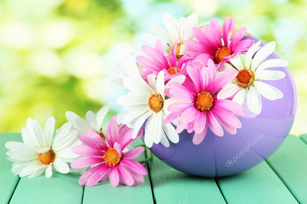 Pot with flowers on a wooden table on the nature background — Stock ...