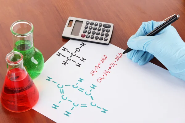 Hand scientist writing formulas Stock Photo by ©belchonock 25669443
