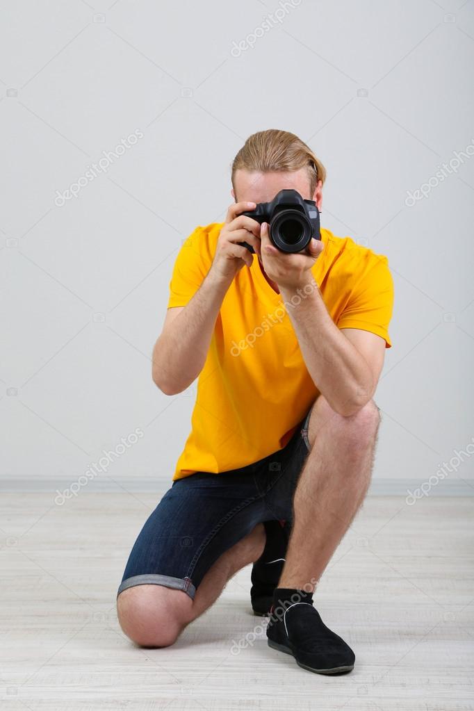 Handsome photographer with camera,on gray background Stock Photo by ...