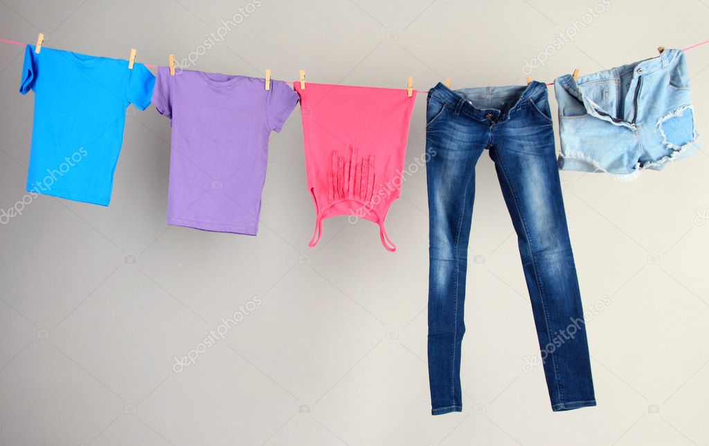 Laundry line with clothes on wall background — Stock Photo © belchonock ...