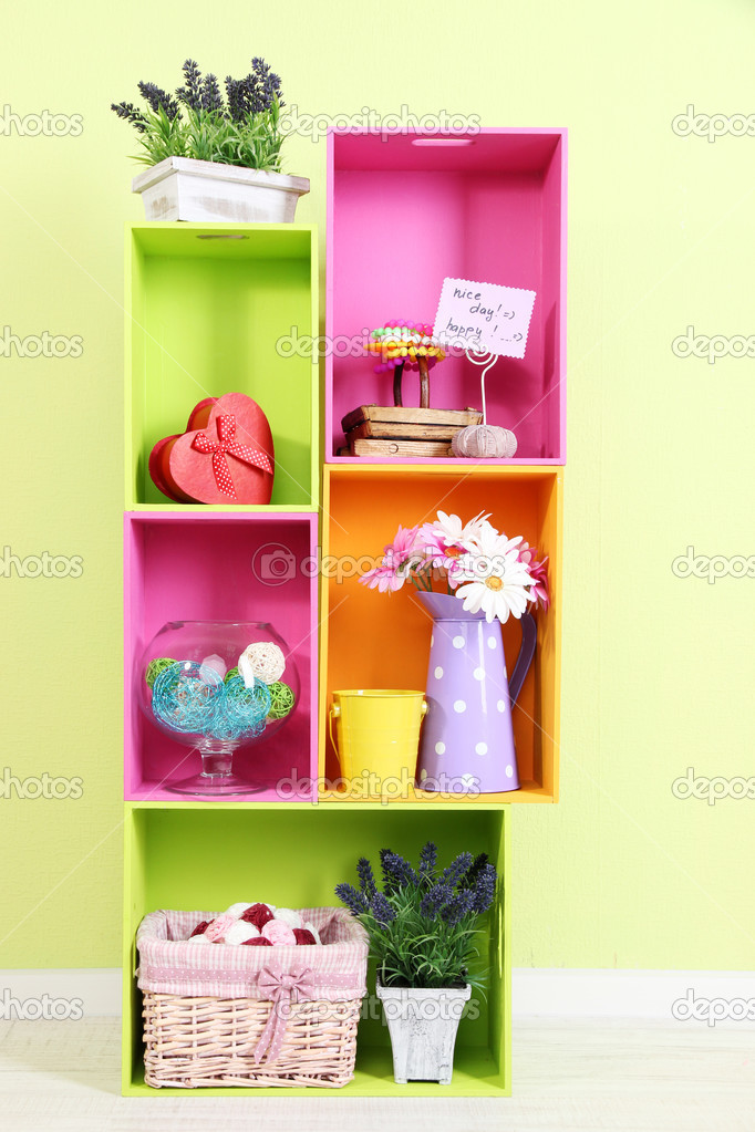 Shelves of different bright colors with decorative addition on wall ...