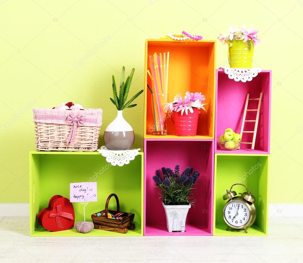 Shelves of different bright colors with decorative addition on wall ...