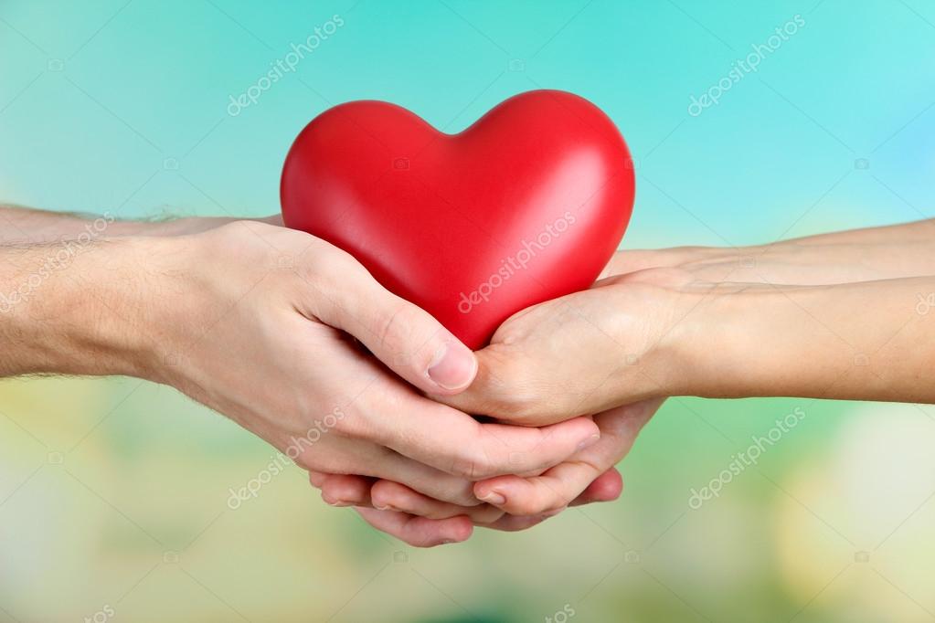 Heart in hands on nature background Stock Photo by ©belchonock 29457569