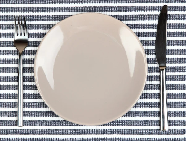 Knife, color plate and fork, on color background Stock Photo by ...