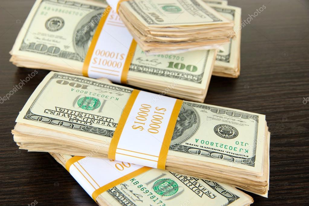 Stacks of money on wooden table — Stock Photo © belchonock #30110913