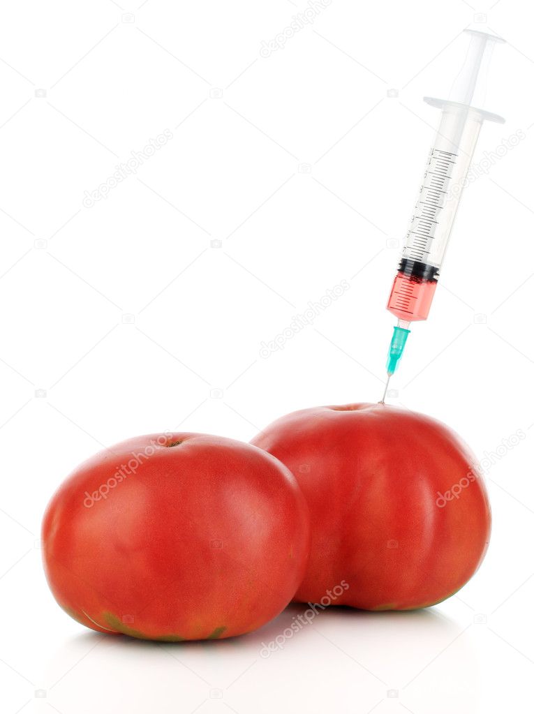 Injection into fresh red tomato isolated on white Stock Photo by ...