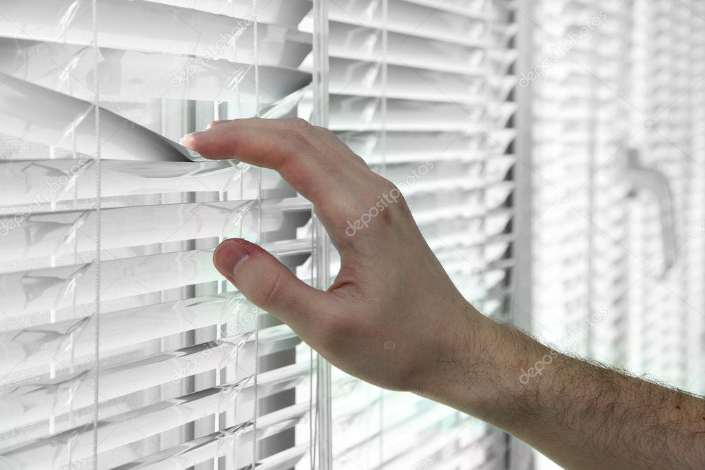 Someone looking out of window opening blinds — Stock Photo © belchonock ...