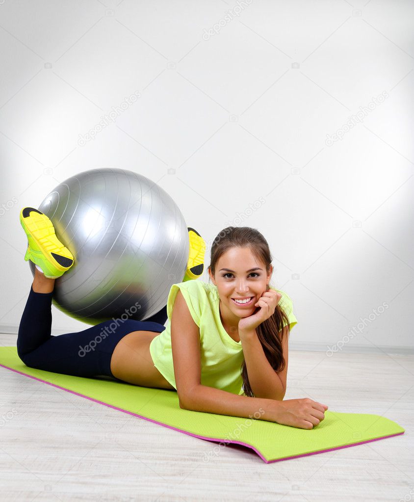 Beautiful young girl doing exercises at home — Stock Photo © belchonock ...