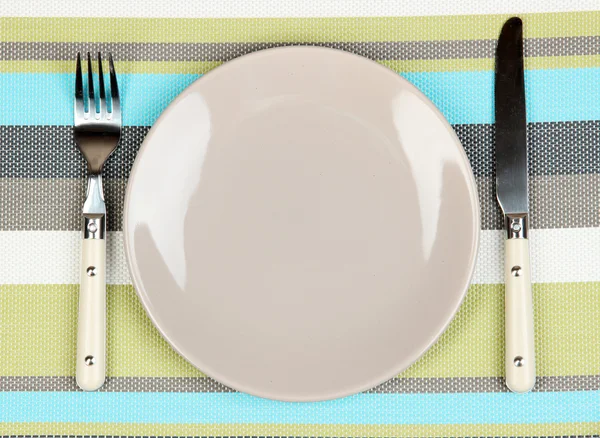 Knife, color plate and fork, on color background Stock Photo by ...