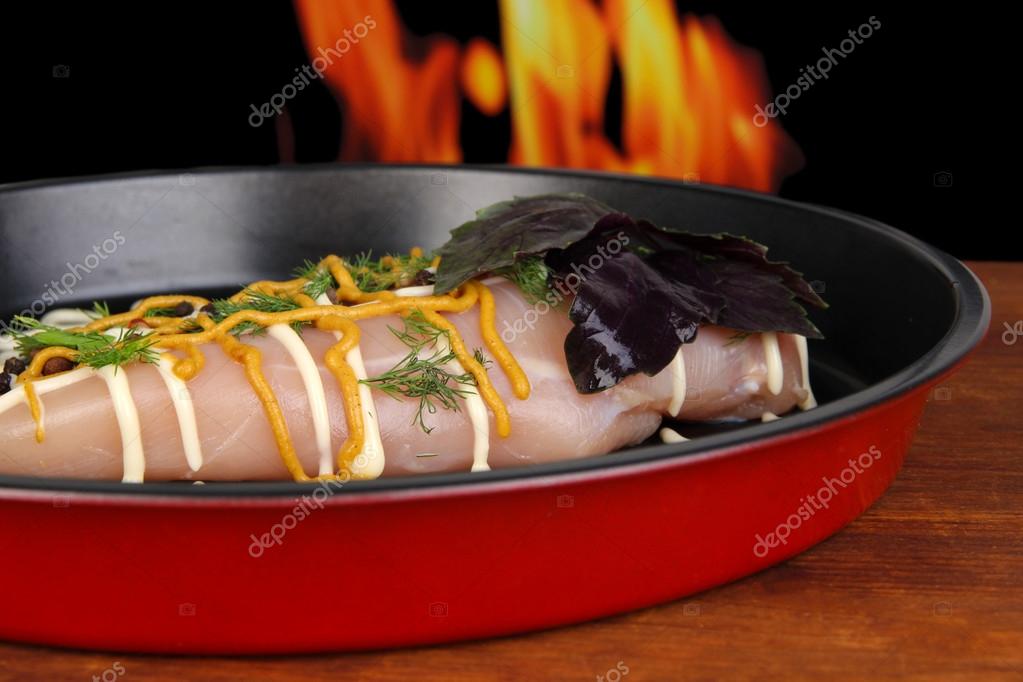 Raw chicken fillets on dripping pan, on fire background Stock Photo by ...