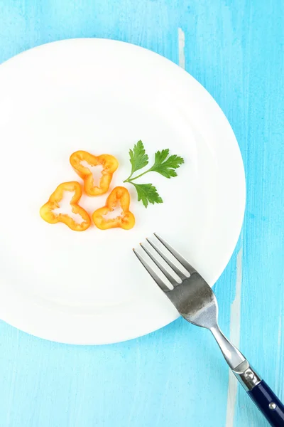Small portion of food on big plate on wooden table close-up — Stock ...