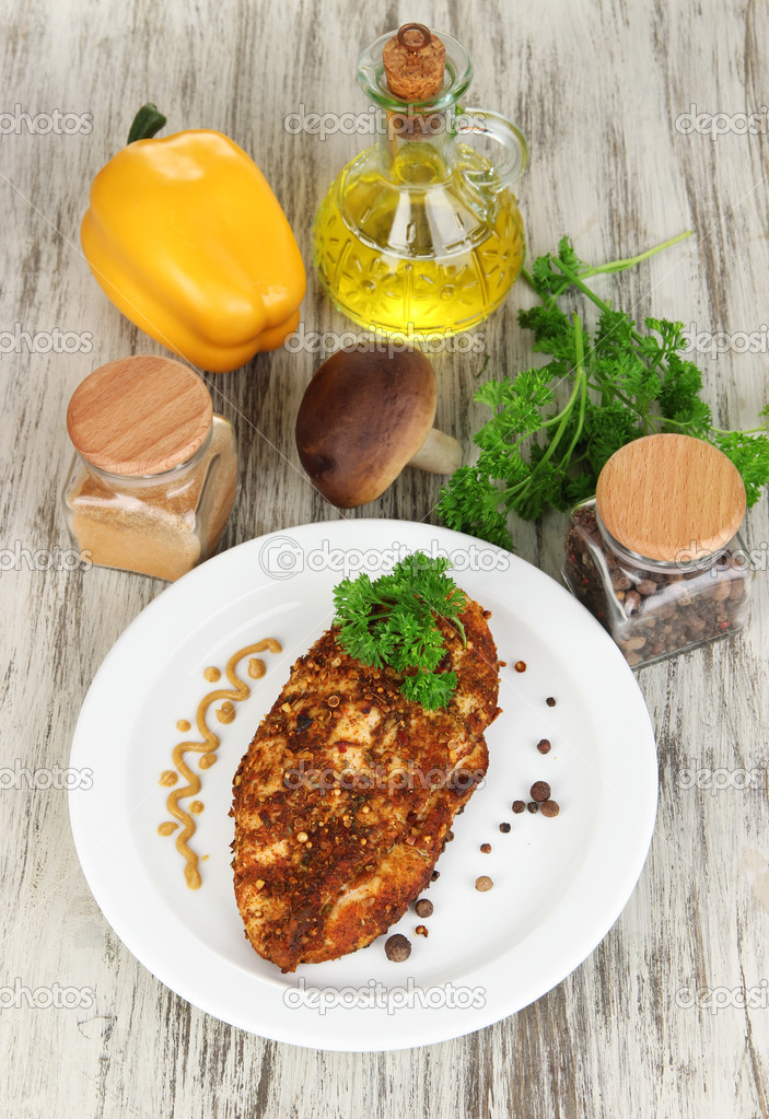 Roasted chicken fillets on white plate and vegetables, on wooden ...