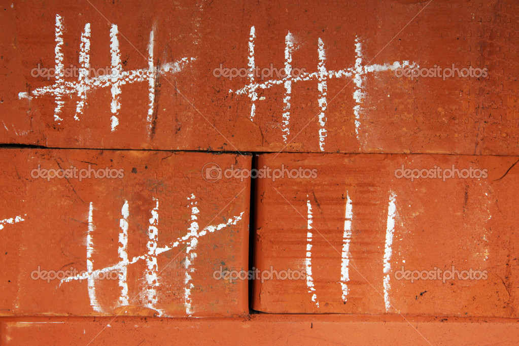 Counting days by drawing sticks on bricks close up Stock Photo by ...
