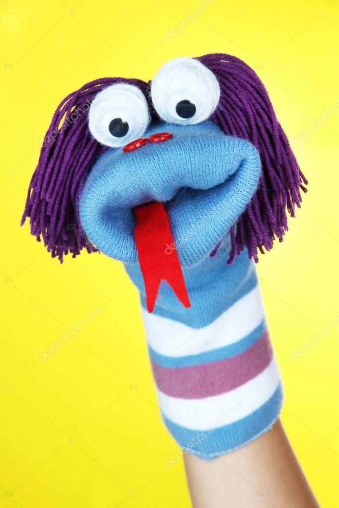 Cute sock puppet on yellow background Stock Photo by ©belchonock 34495967