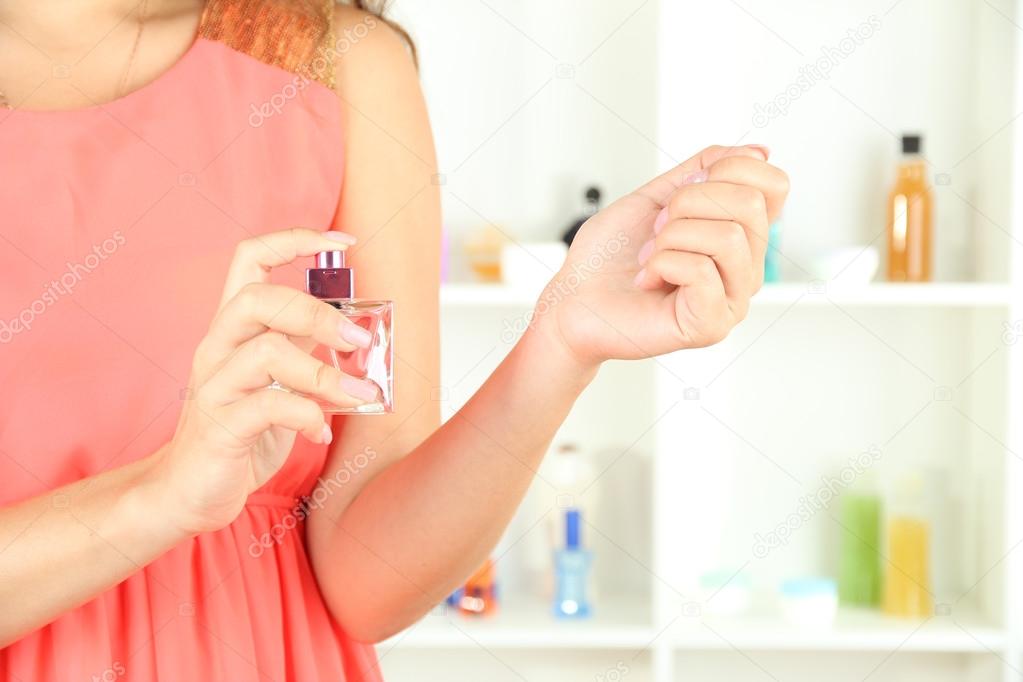 Woman testing perfume on shop windows background — Stock Photo ...