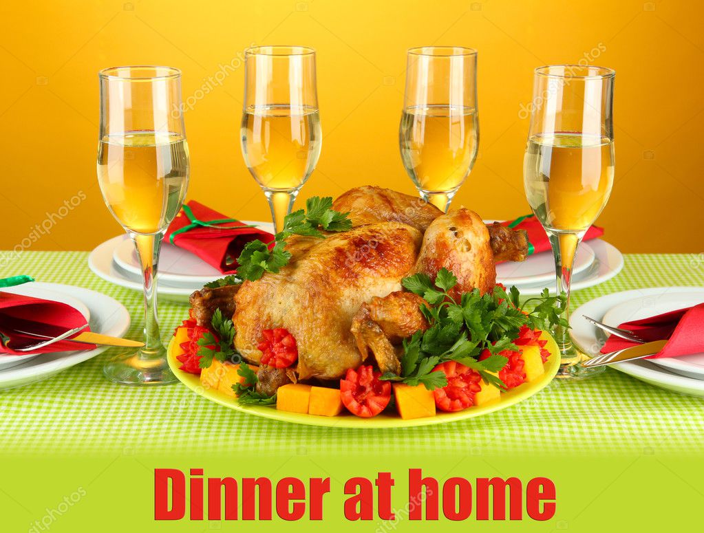 Banquet table with roast chicken on orange background close-up ...