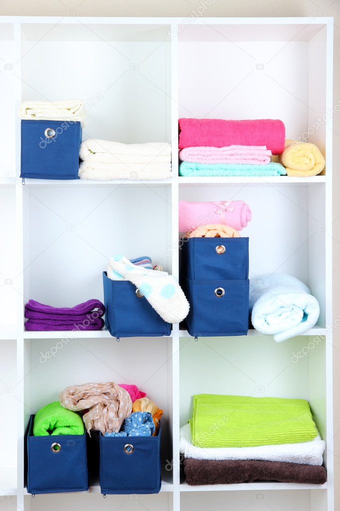 Blue textile boxes in white shelves — Stock Photo © belchonock #36121005