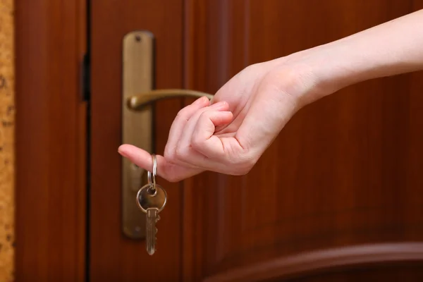 Locking up or unlocking door with key in hand Stock Photo by ...