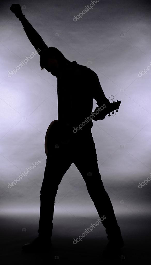 Guitarist silhouette on dark gray background Stock Photo by ©belchonock ...