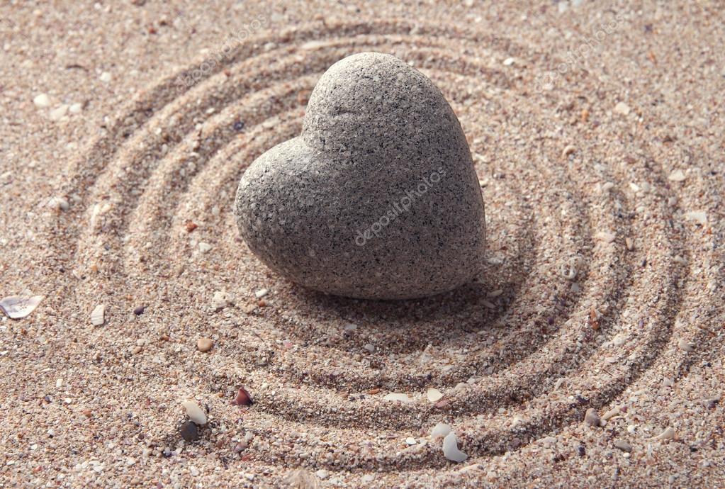 Grey zen stone in shape of heart, on sand background Stock Photo by ...