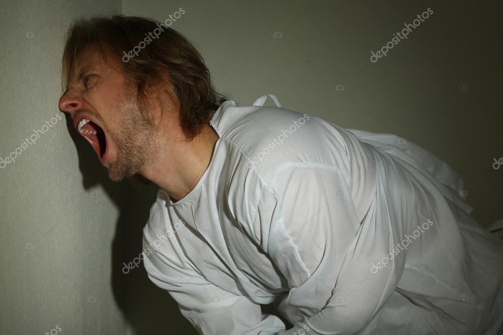 Hombre mentalmente enfermo con camisa de fuerza en la esquina de la ...