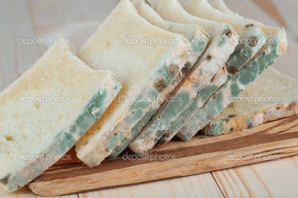 Mouldy bread on cutting board, on wooden background Stock Photo by ...