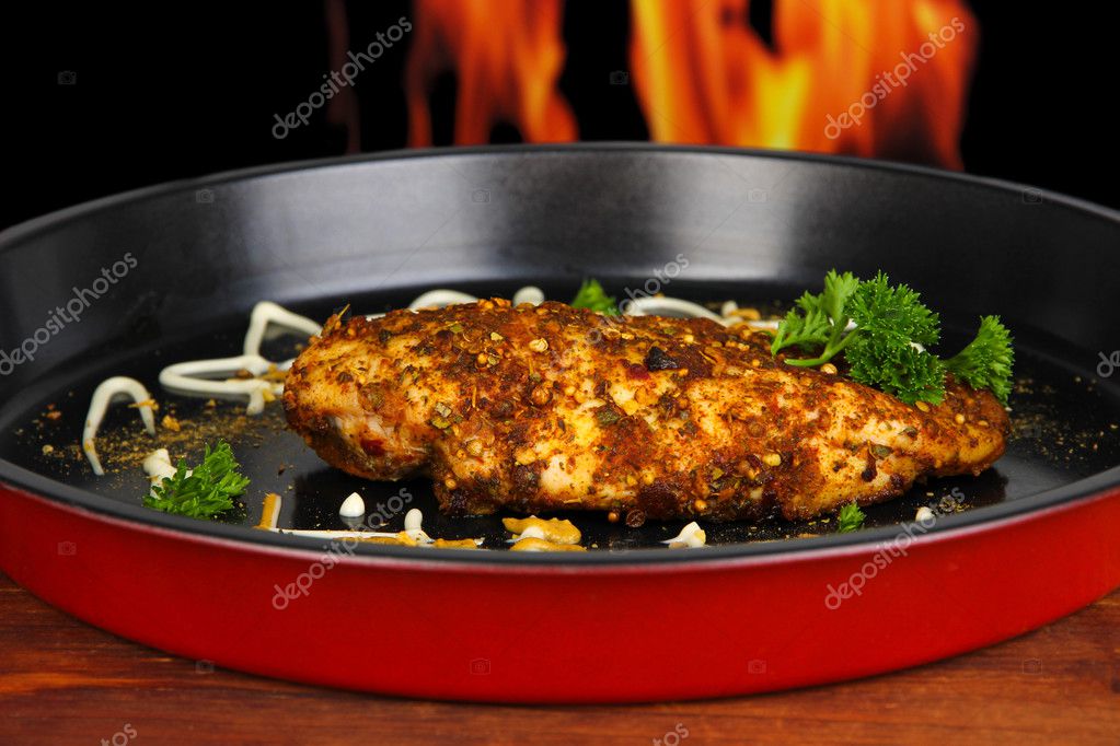 Roasted chicken fillets on dripping pan, on fire background Stock Photo ...