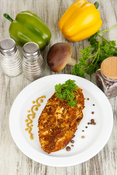 Roasted chicken fillets on white plate and vegetables, on wooden ...