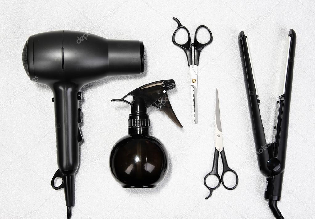 Hairdressing tools on silver background Stock Photo by ©belchonock 37957289