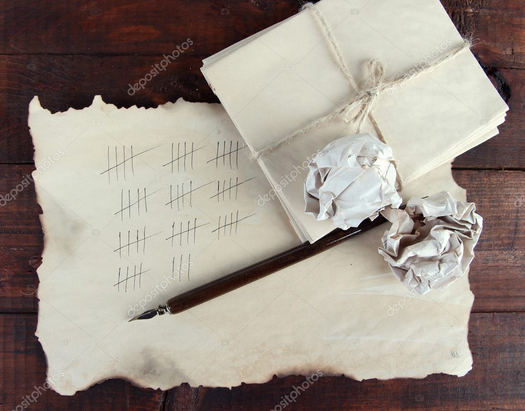 Counting days by drawing sticks on paper on wooden background Stock ...