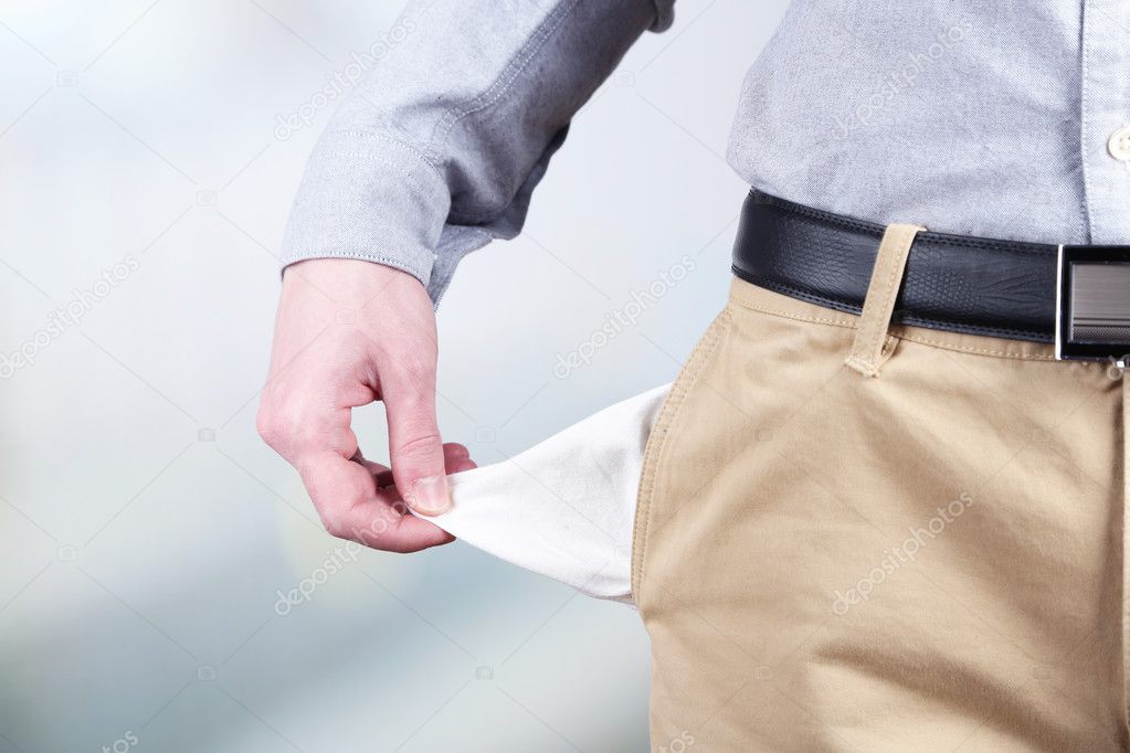 Man showing his empty pocket on bright background Stock Photo by ...