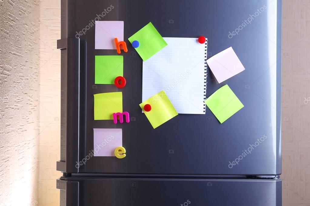 Empty paper sheets and colorful magnets on fridge door Stock Photo by ...