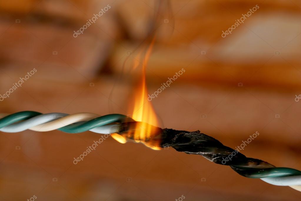 Short circuit, burnt cable, on dark color background — Stock Photo ...